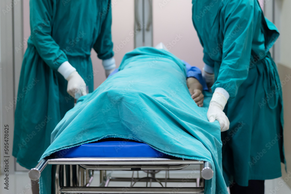 Surgical Team Push Patient Bed Out of Operation Room After the Surgical ...