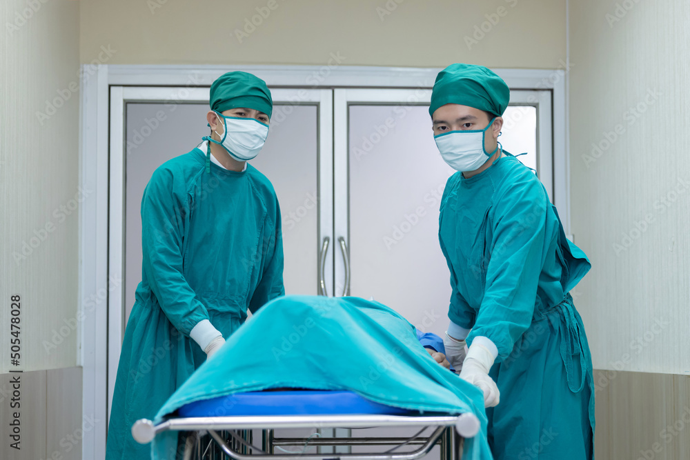 Surgical Team Push Patient Bed Out of Operation Room After the Surgical ...