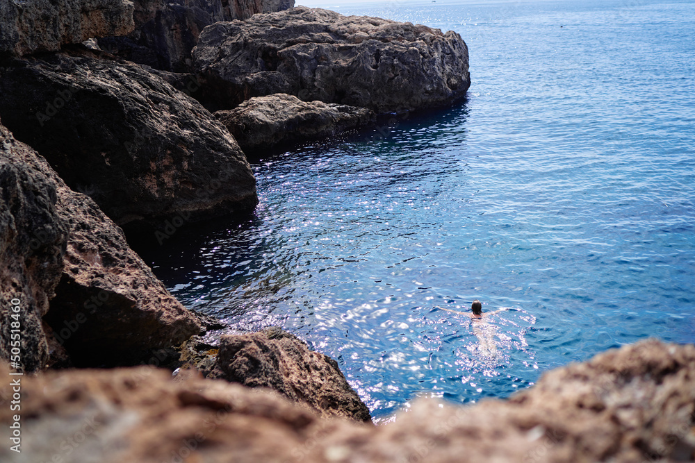 Vacation. Young woman swimming and bathing at sea rock lagoon. Stock ...
