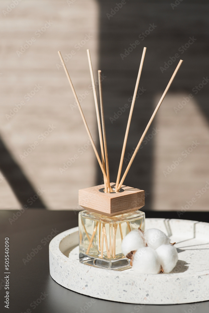 Transparent bottle of aroma diffuser on the terazzo podium on blurred ...