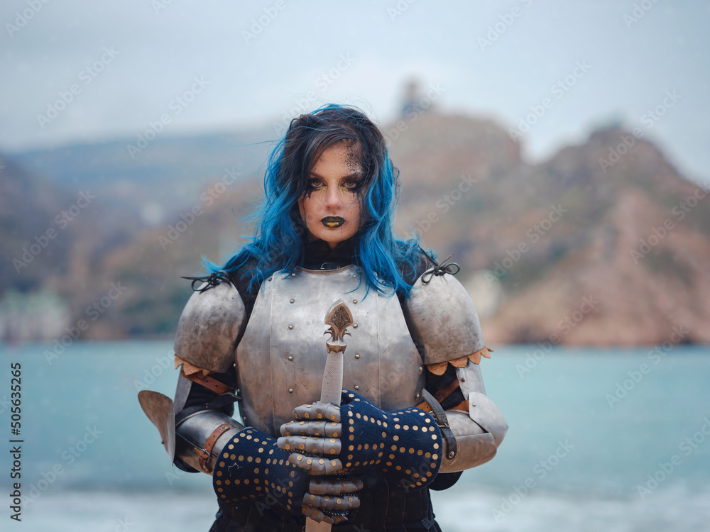 Medieval knight woman in armor prays, blessing before the battle. Stock ...
