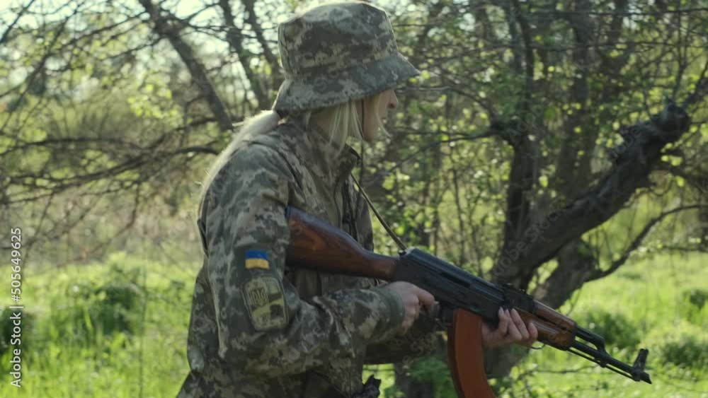 Young Ukrainian female soldier in camouflage uniform with an assault ...