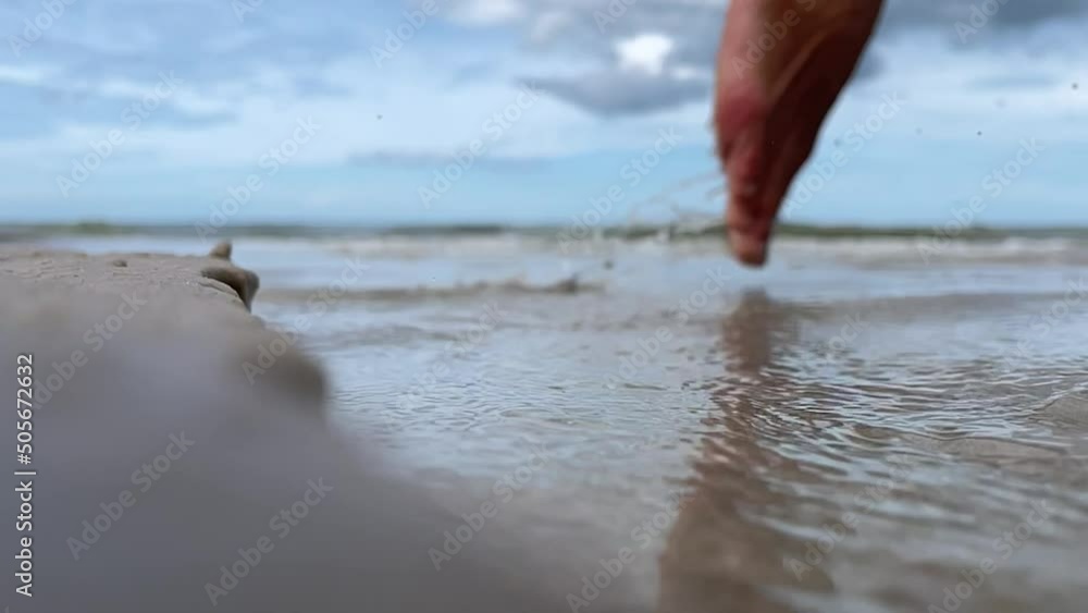 Man running barefoot on beach close up slow motion seafront splash of ...