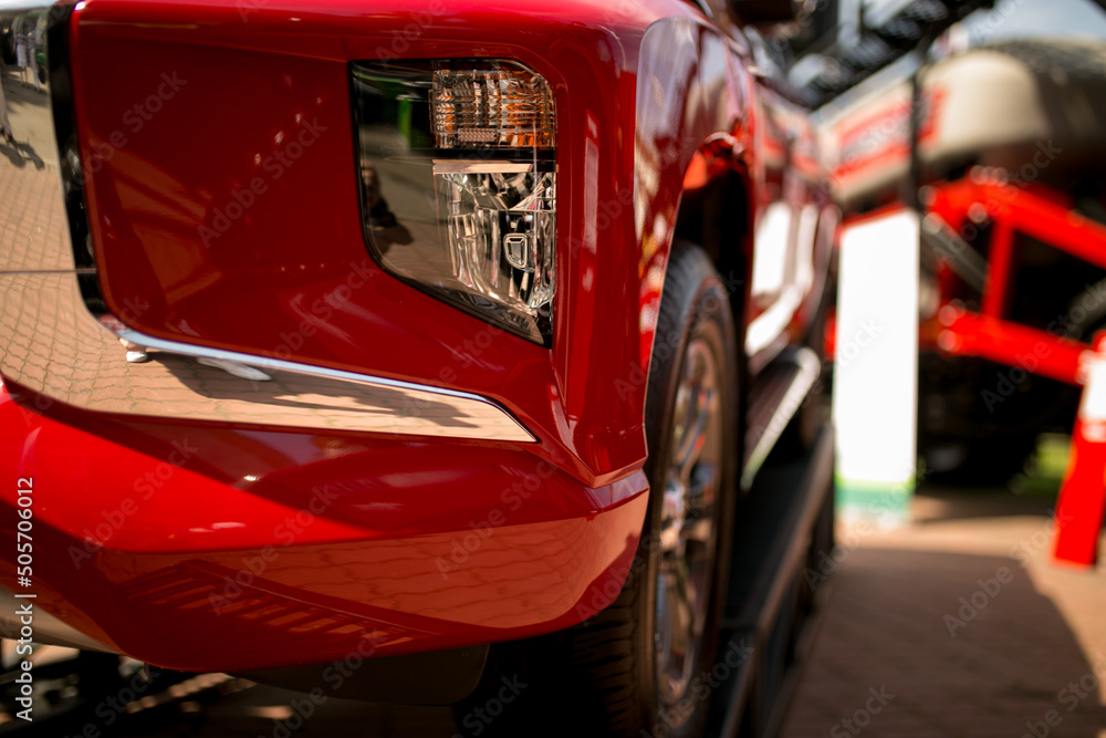 Headlights of a red car. headlights of a new red car. Headlight on ...