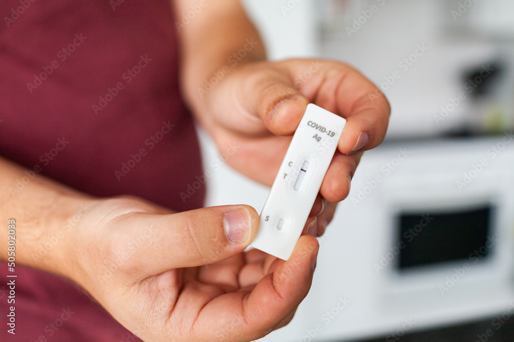 Person holding covid-19 rat rapid antigen test Stock Photo | Adobe Stock