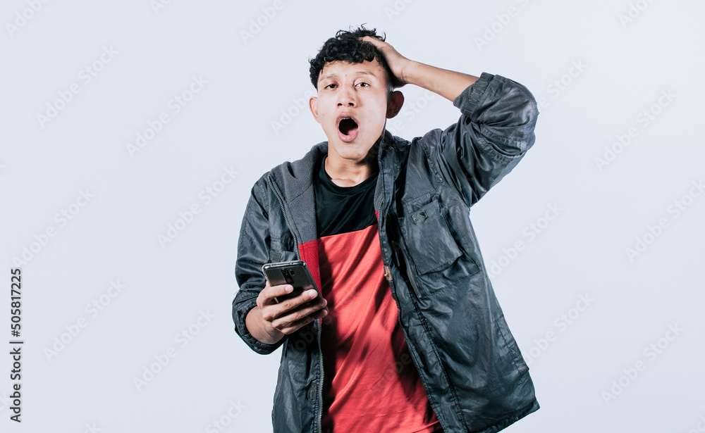 Fotka „Surprised people with his cell phone holding his head, guy with ...