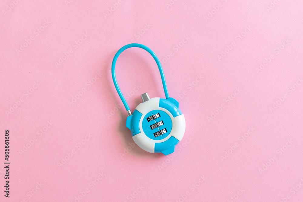 Combination lock on light pink background. Password sign. Close up, top ...