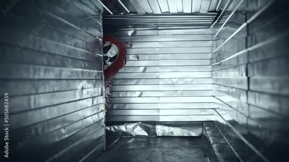 Scary clown attacks in a closed ventilation duct. Scary psychopath in a ...