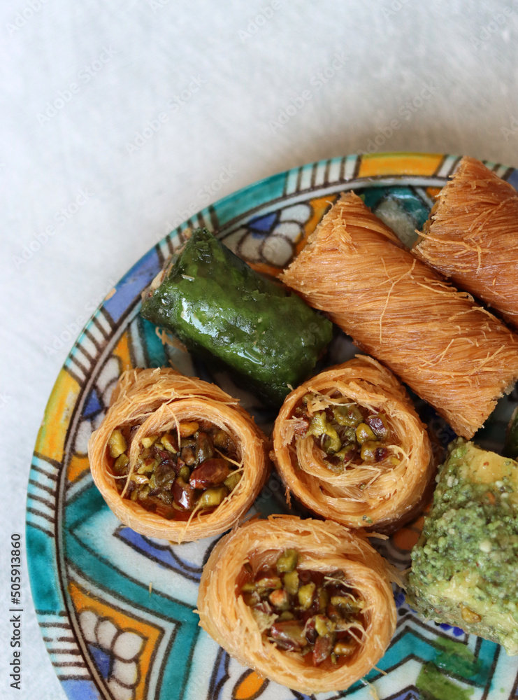 Arabian sweets on a plate. Traditional pastries made of pistachio and ...