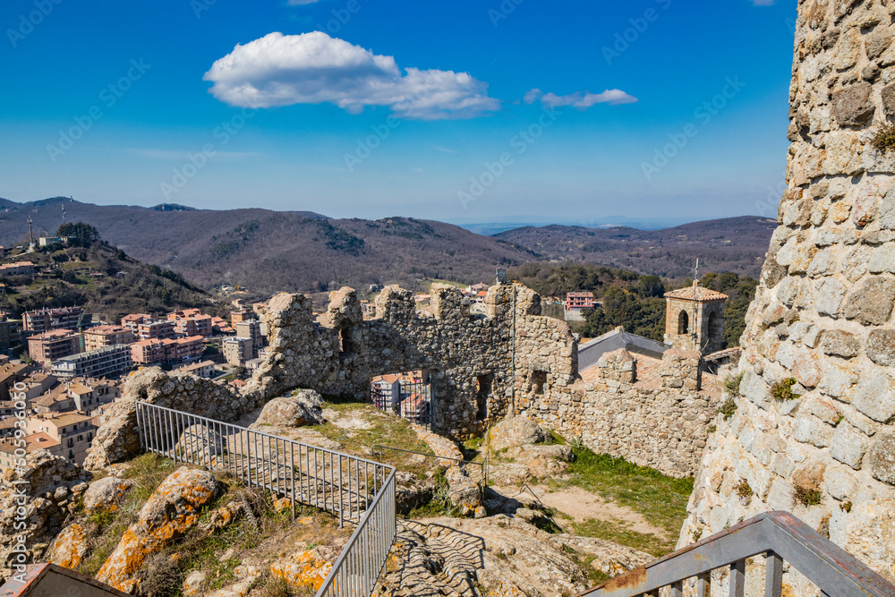 The small village of Tolfa, in Lazio. The remains of the ancient walls ...