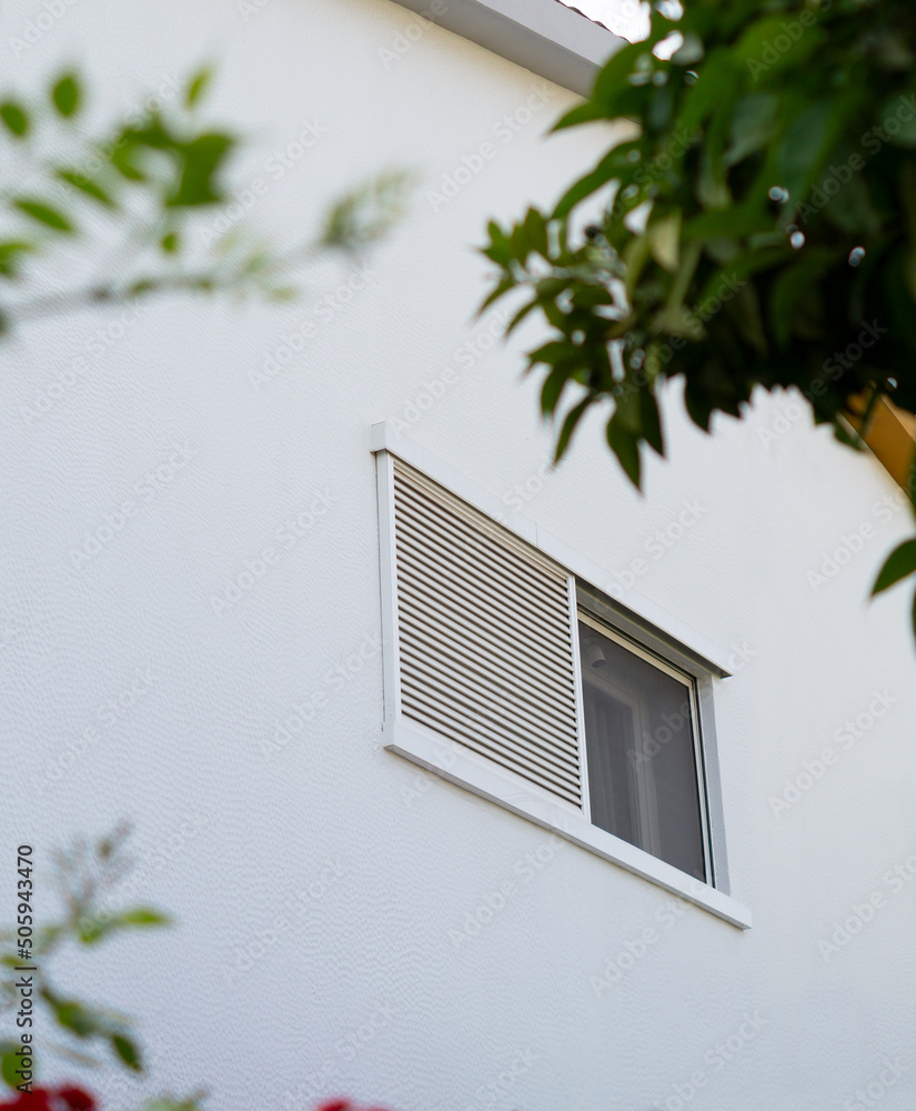 Facade of a modern house. Window protected by a security camera. House ...