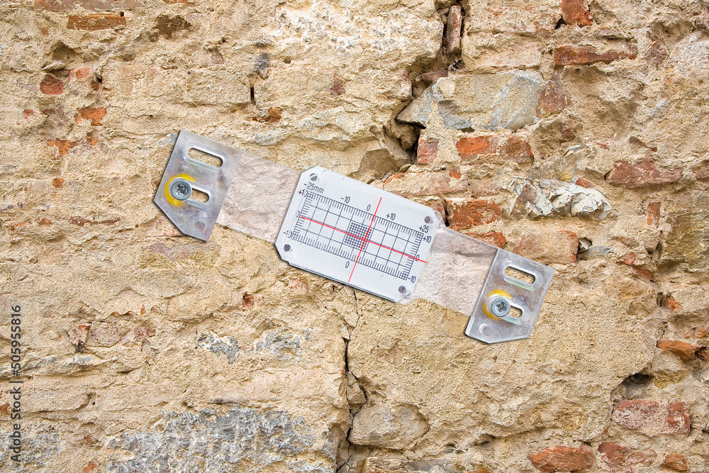 Deep crack in a damaged old stone wall cause due to subsidence of ...
