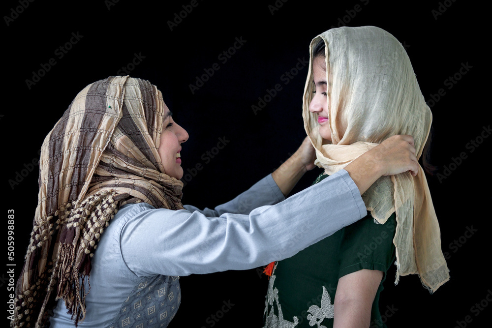 Pakistani Muslim mother dressing up her daughter girl with traditional ...