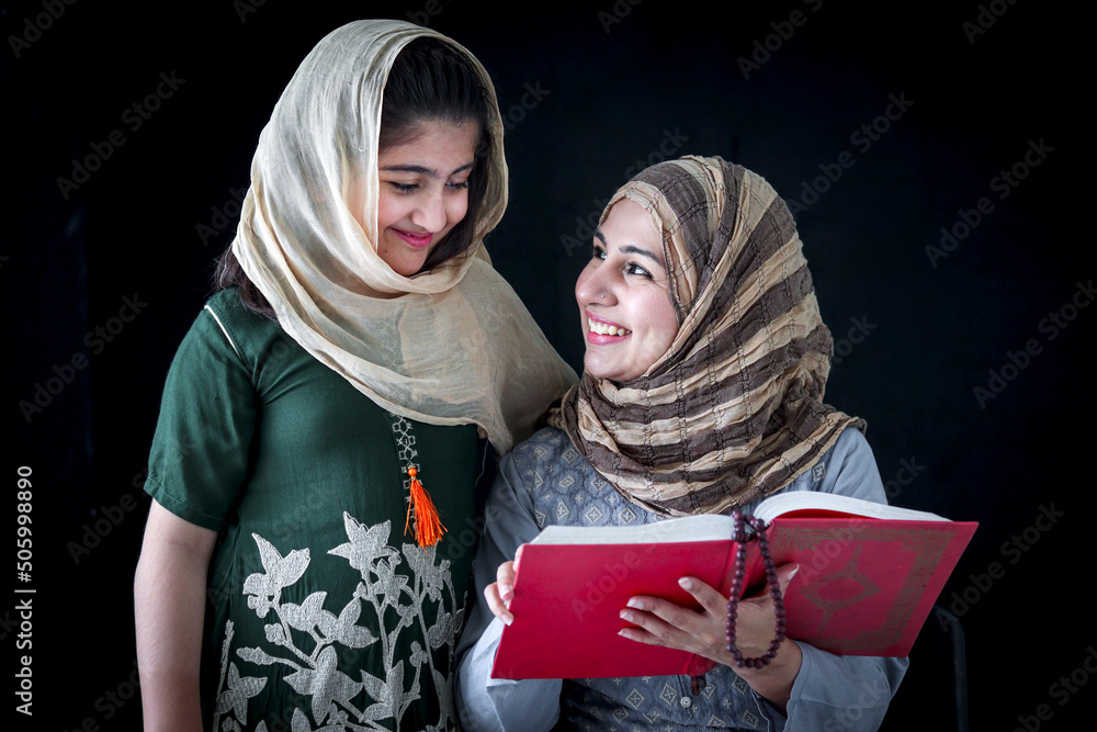 Beautiful Pakistani mother and girl daughter child with hijab reading ...