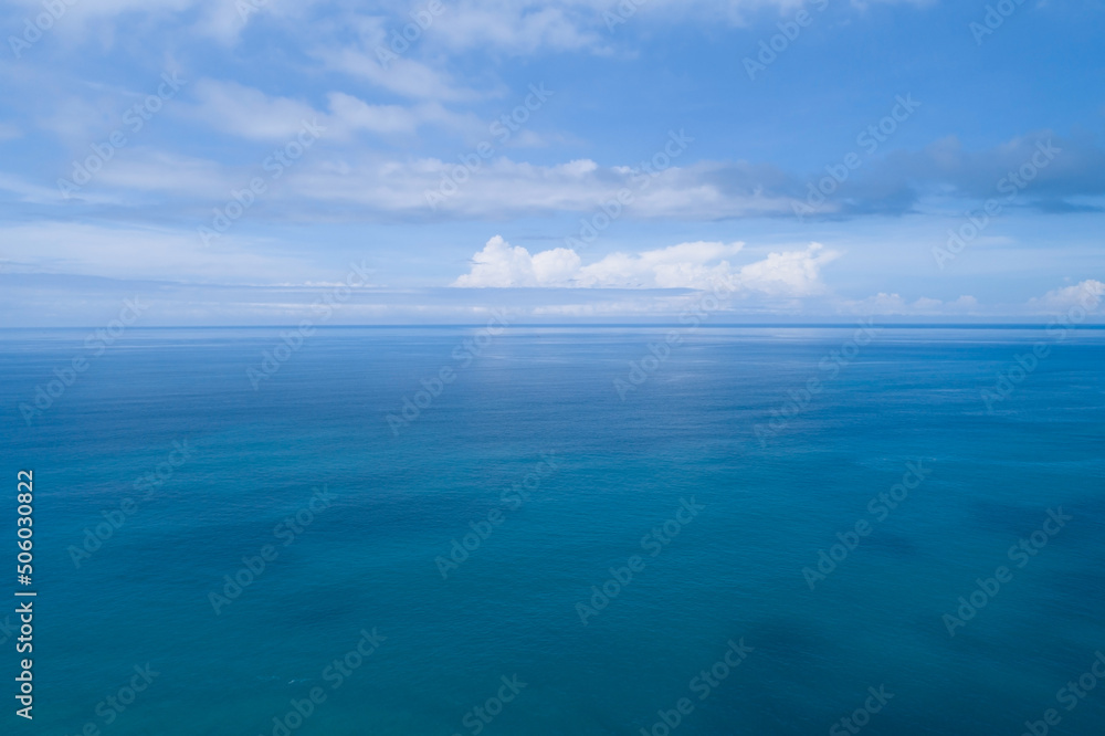Aerial view of a blue sea surface water texture background and sun ...