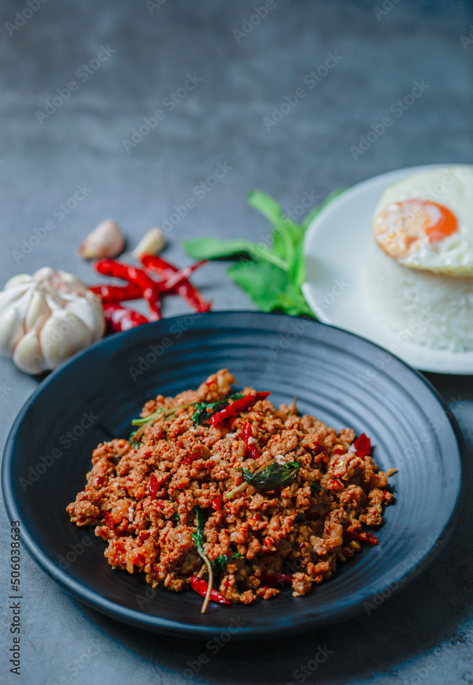 portrait Thai food, beef stir-fried basil rice on texture old cement ...