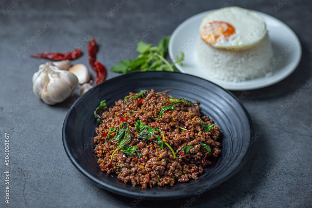 portrait Thai food, beef stir-fried basil rice on texture old cement ...