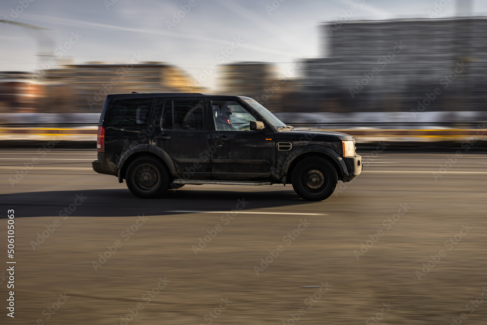 Land Rover Discovery 3 driving on city street with motion blur, side ...