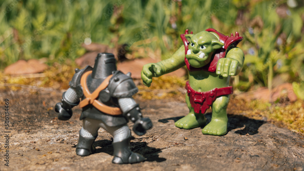 Confrontation between a green ogre and a knight in armor, in the middle ...