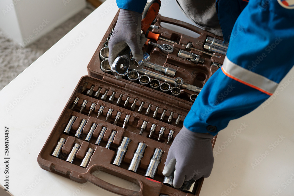 professional worker taking the instrument tool from the toolbox set ...