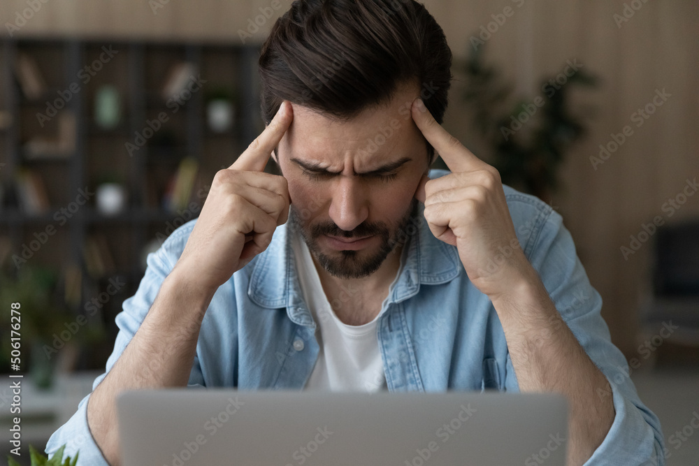 Mental tension. Stressed male sit by pc contemplate think hard with ...