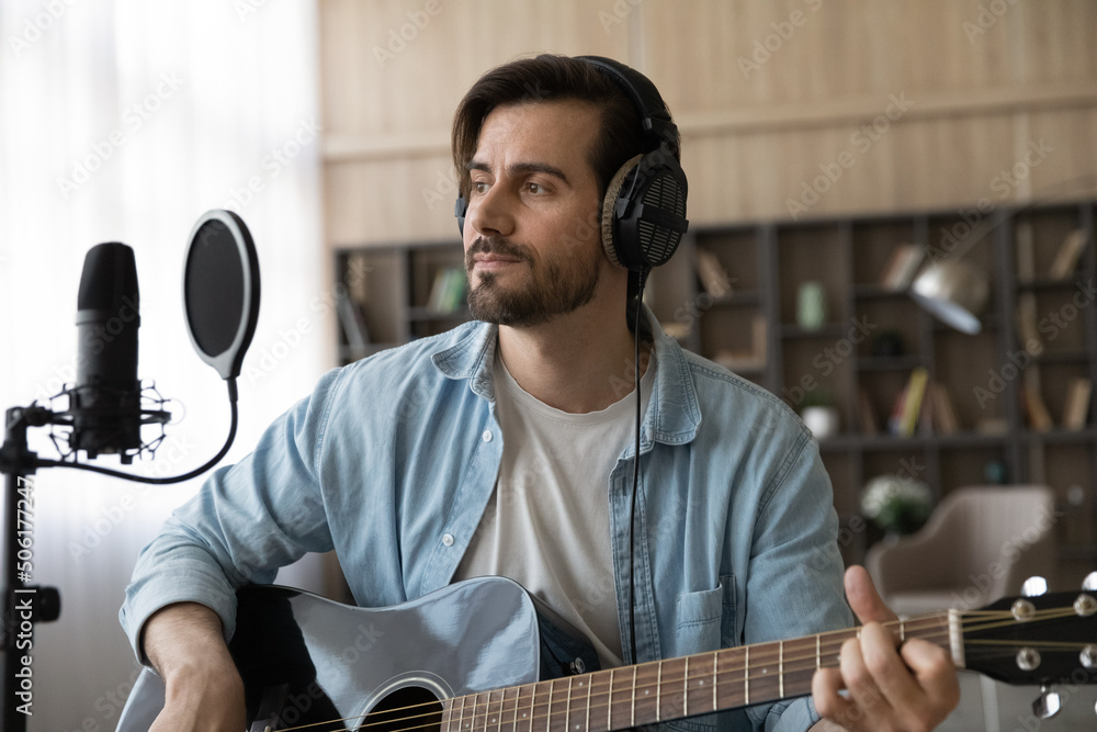 Performing song. Inspired man singer and music writer amateur sit in ...