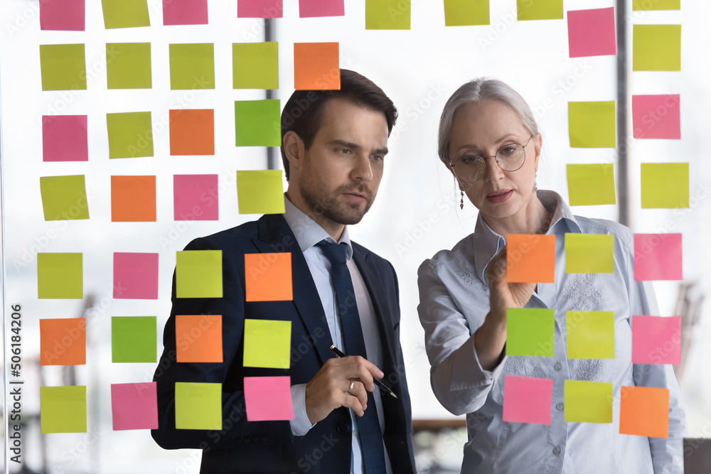 Old and young employees engaged in projects development, ideas creation ...