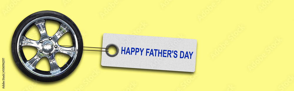 Happy Father's Day. Words on the tag, and auto wheel In a yellow ...