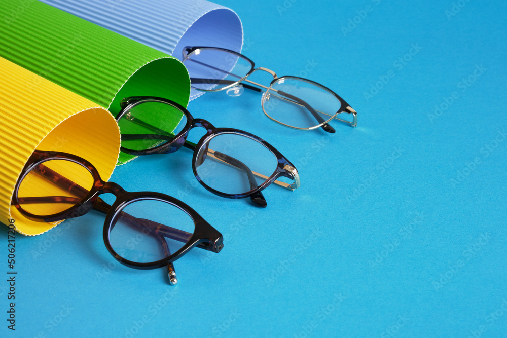 rolls of corrugated cardboard and several pairs of stylish glasses ...