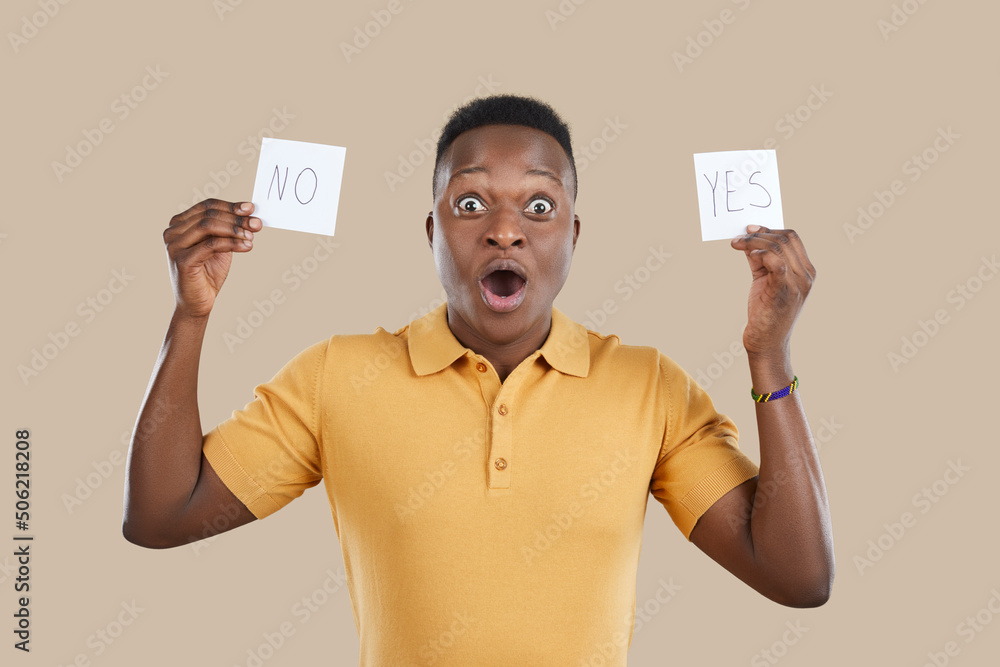 Portrait man with YES NO sticky post it note cards and funny face ...