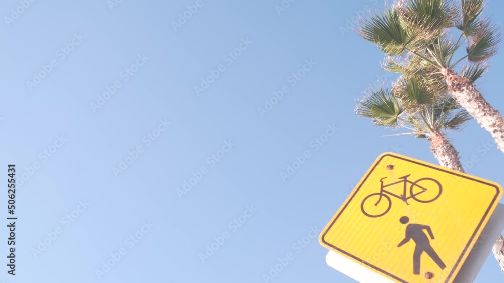 Pedestrian and bike crossing warning yellow road sign on city street ...