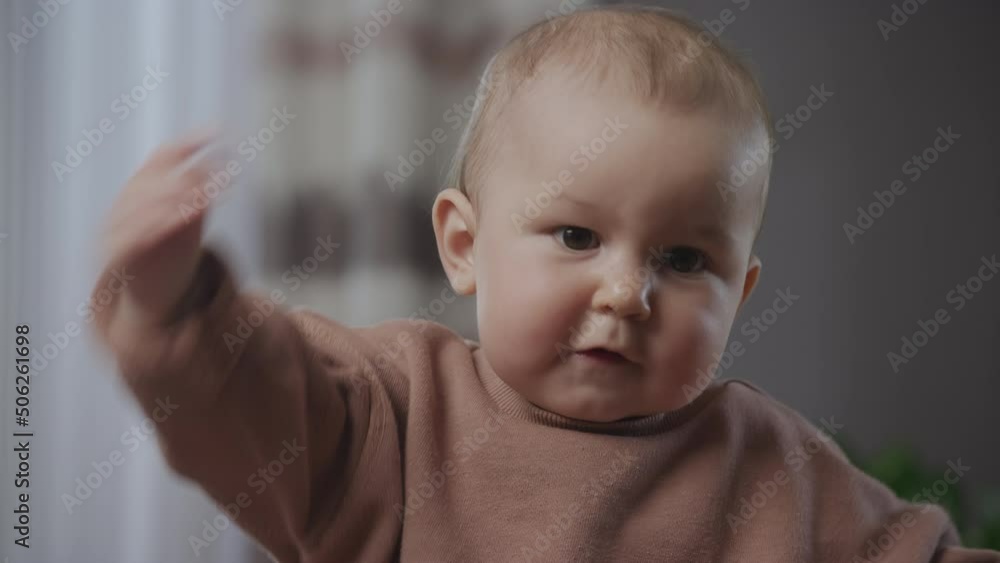 Cute baby boy child waving his hand with a bye bye gesture and laughing ...