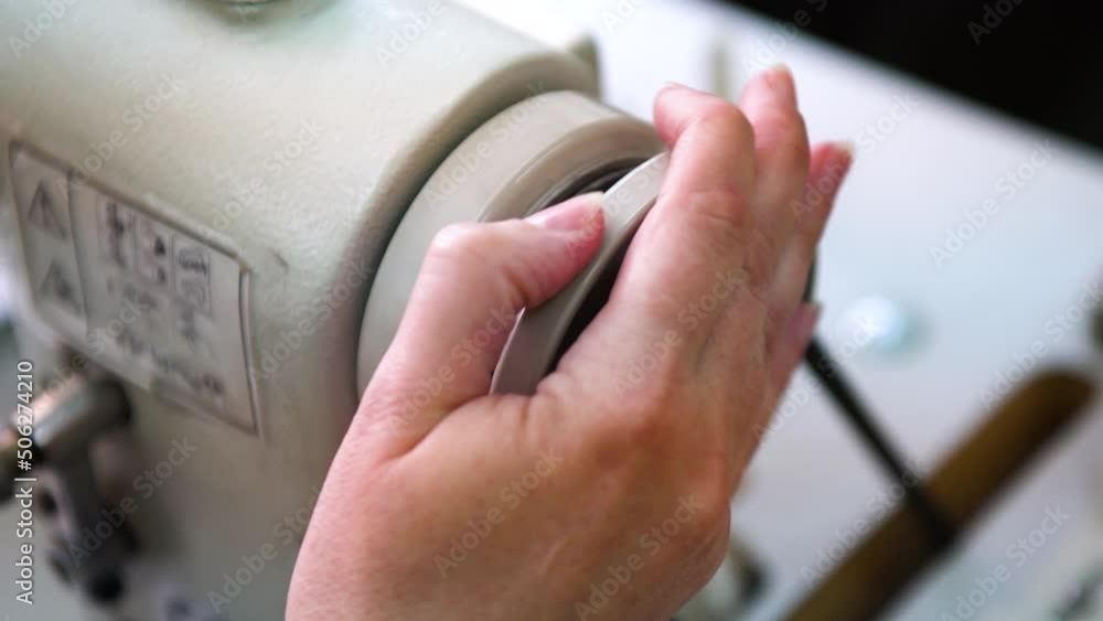 Video „An industrial sewing machine driven by a belt stops. The belt ...