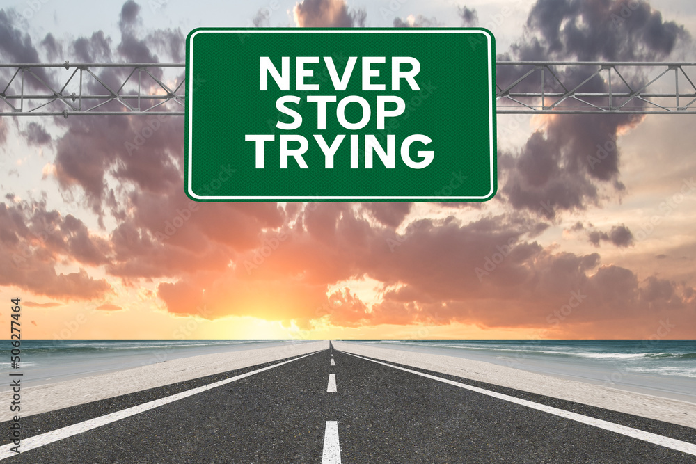 Never Stop Trying highway sign with road leading to the horizon. Stock ...