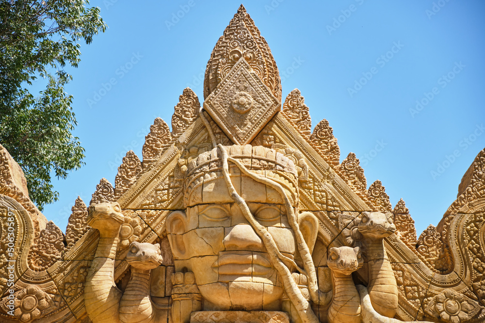 Detail model of an Asian Hindu temple, with a sculpture of the face of ...