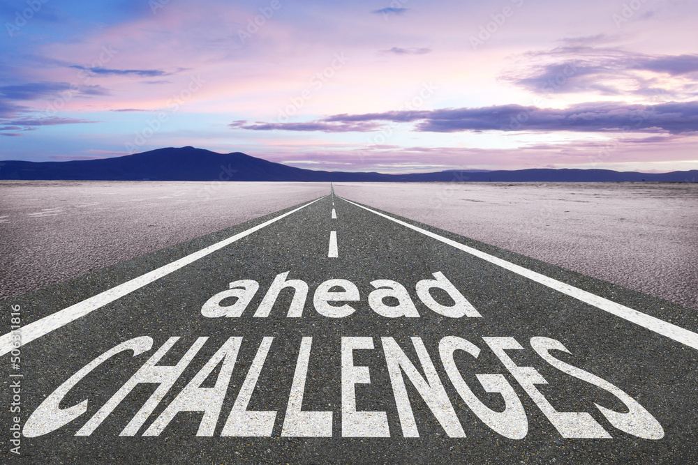 Challenges ahead text on road into the future. Stock Photo | Adobe Stock