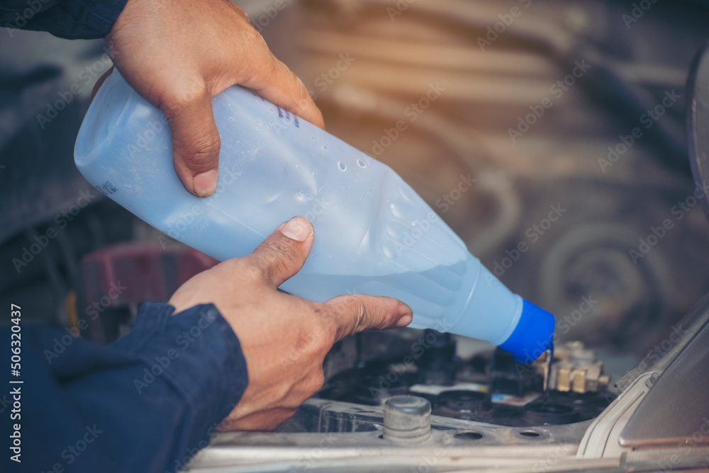 Car Mechanic man hands pouring Deionized purified Distilled water for ...