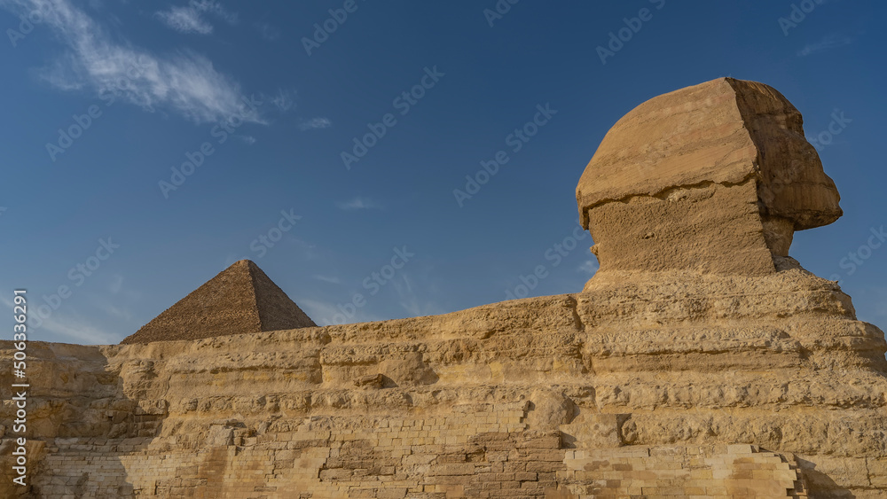 Sculpture of the Great Sphinx against the blue sky. Close-up. Profile ...