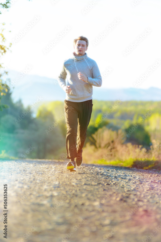 Running man jogging in rural nature at beautiful summer day. Sport ...