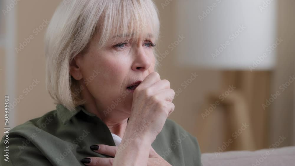 Portrait old woman coughing at home. Close up unwell Caucasian aging ...