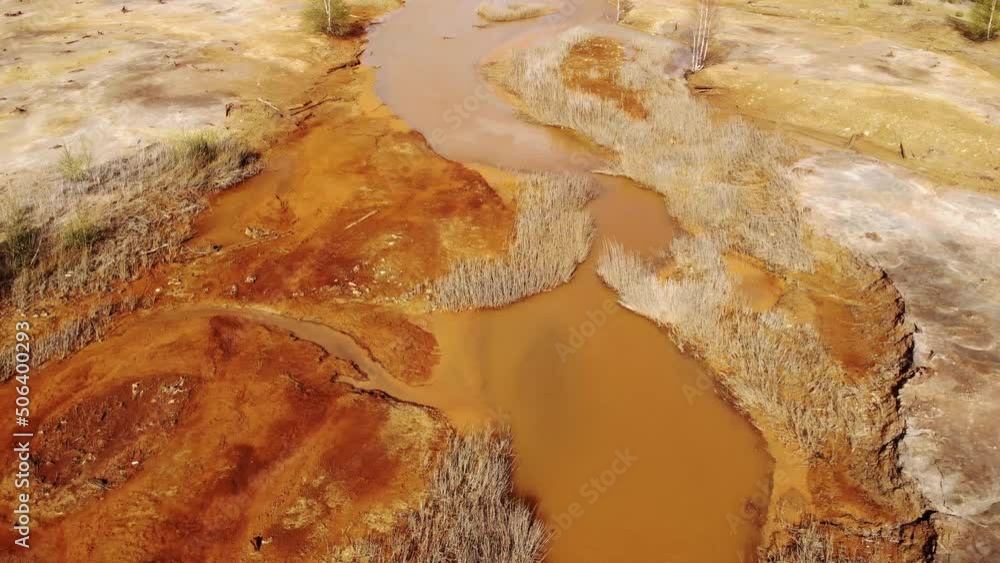 Orange soil is contaminated with heavy metals from an industrial plant ...