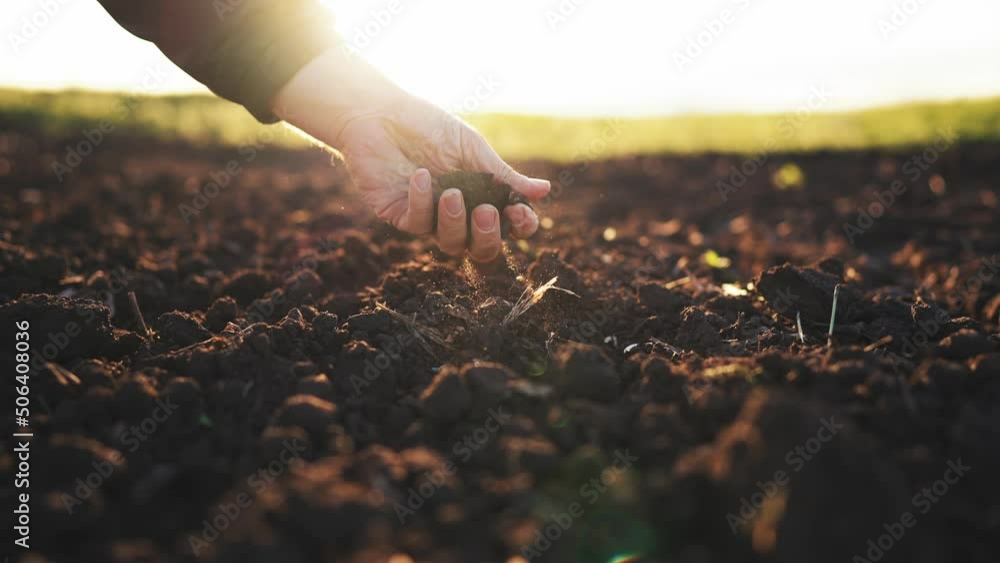 Farmer hand scooping dirt on a field at sunset. Man grabbing the soil ...