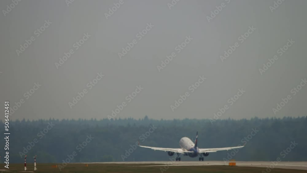 Passenger airplane takes off, departure. Rear view, the jet plane is ...