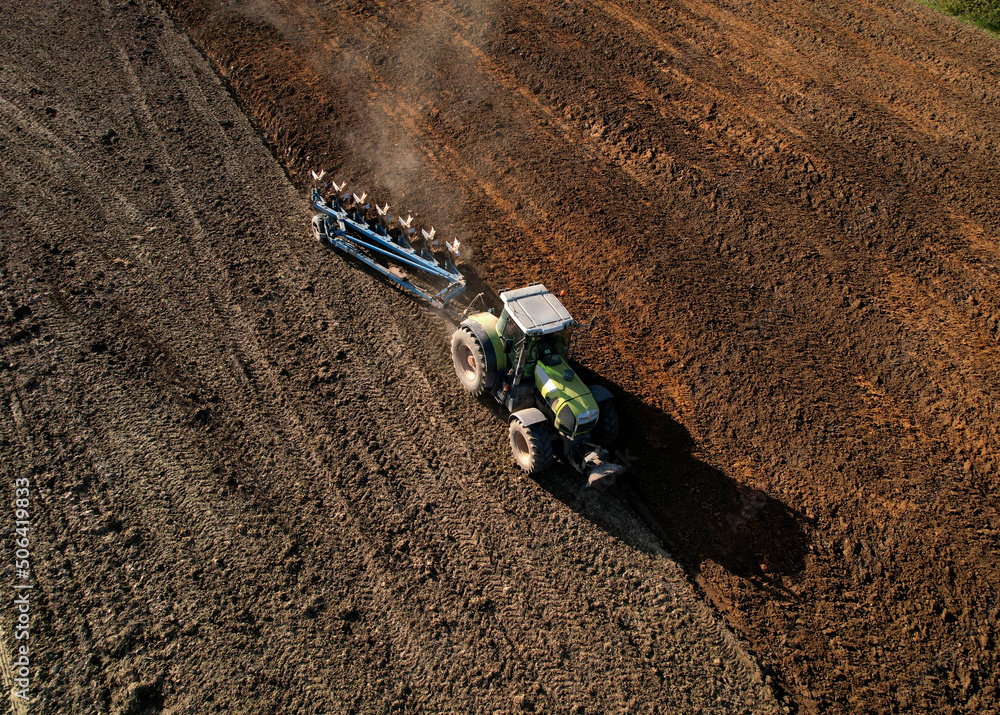 Tractor with plow on soil cultivating. Tractor plowing field, top view ...