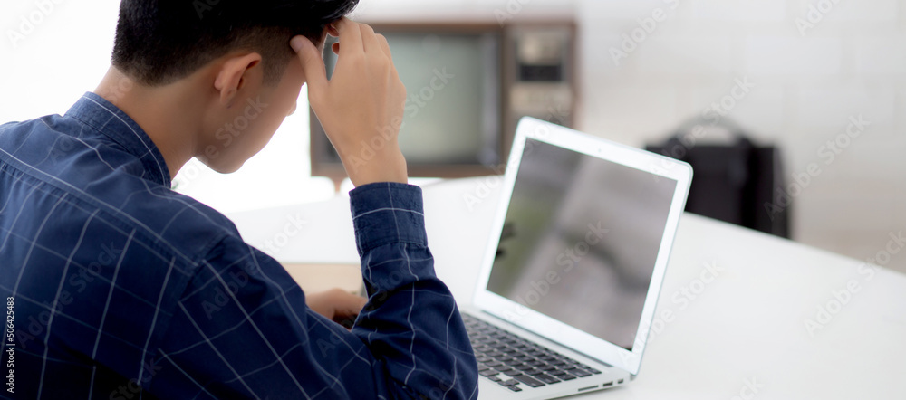 Young asian business man headache during working on laptop computer ...