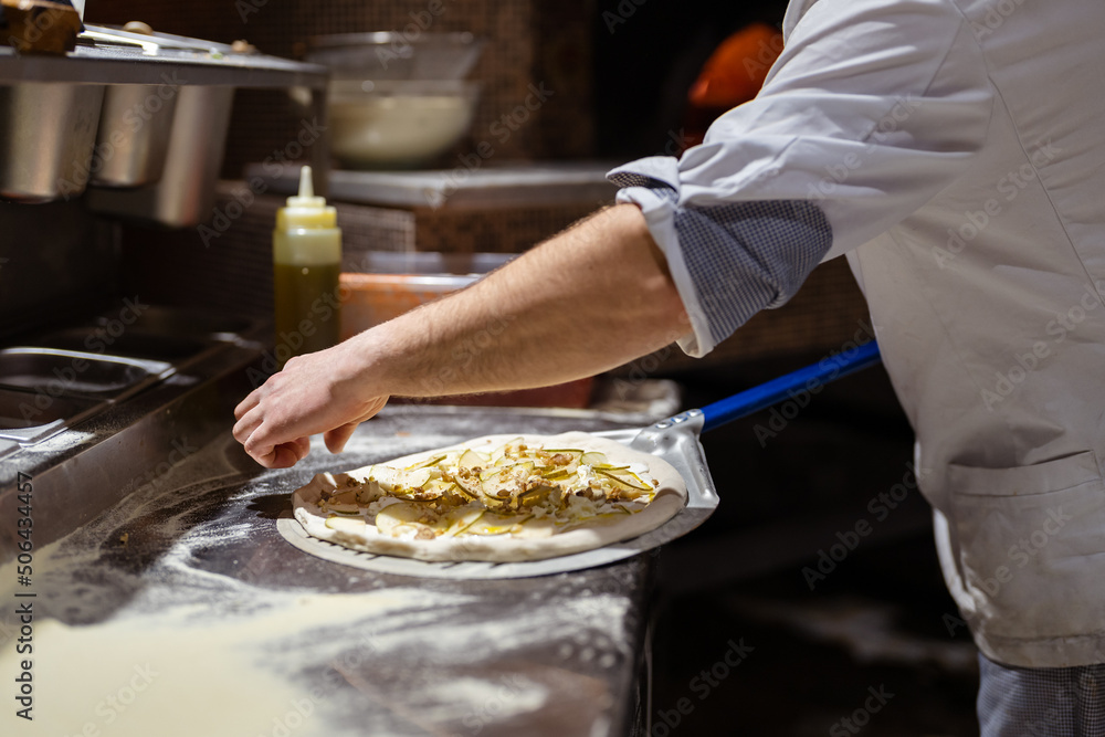 Pizza making process. Male chef hands making authentic pizza in the ...