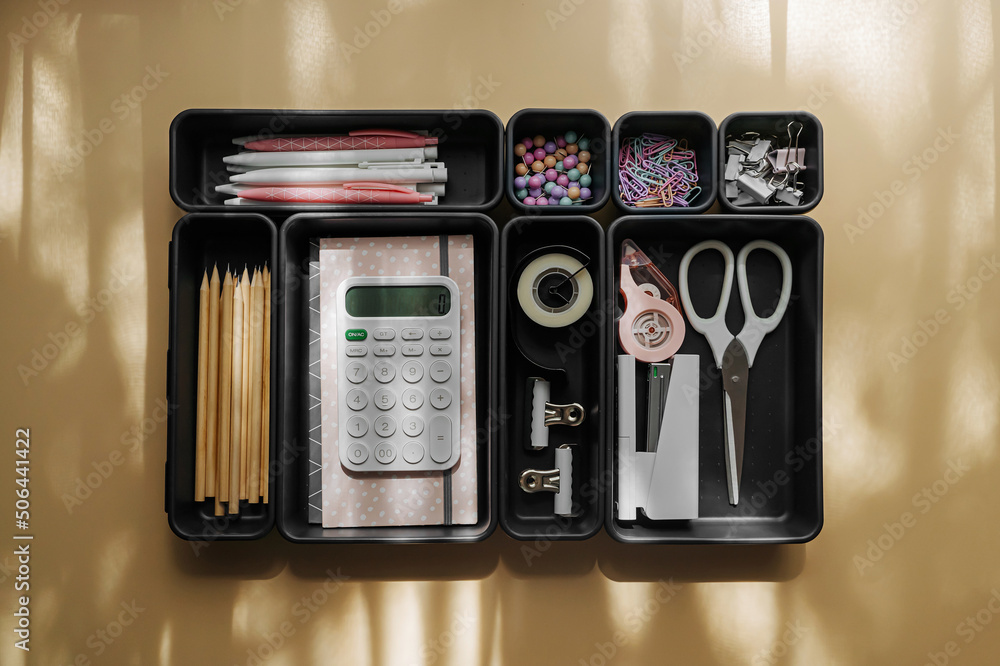 Stylish stationery is arranged in black organizers. Creative Drawer ...