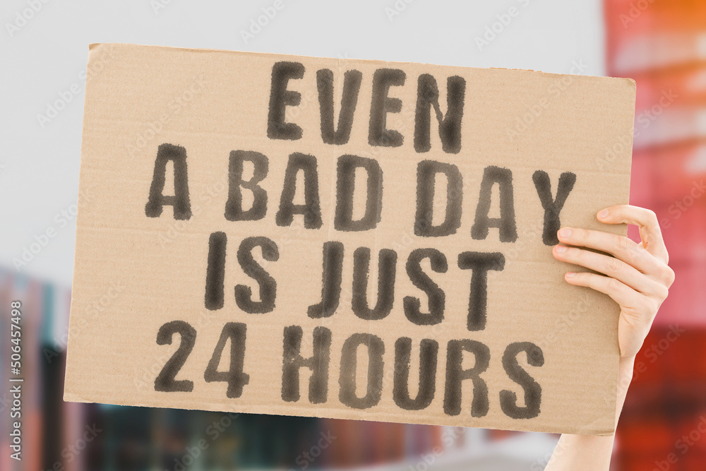 The phrase " Even a bad day is just 24 hours " is on a banner in men's ...