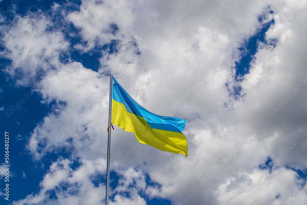 Ukrainian Flag, blue and yellow colors, sky with clouds. National ...