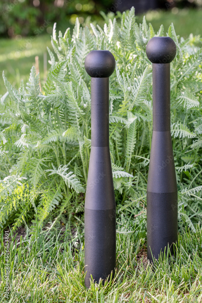 pair of steel clubs in backyard, functional fitness concept, heavy ...